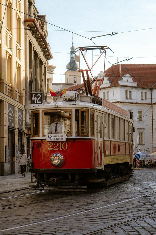 Vintage red tram on Prague Old Town cobblestone streets