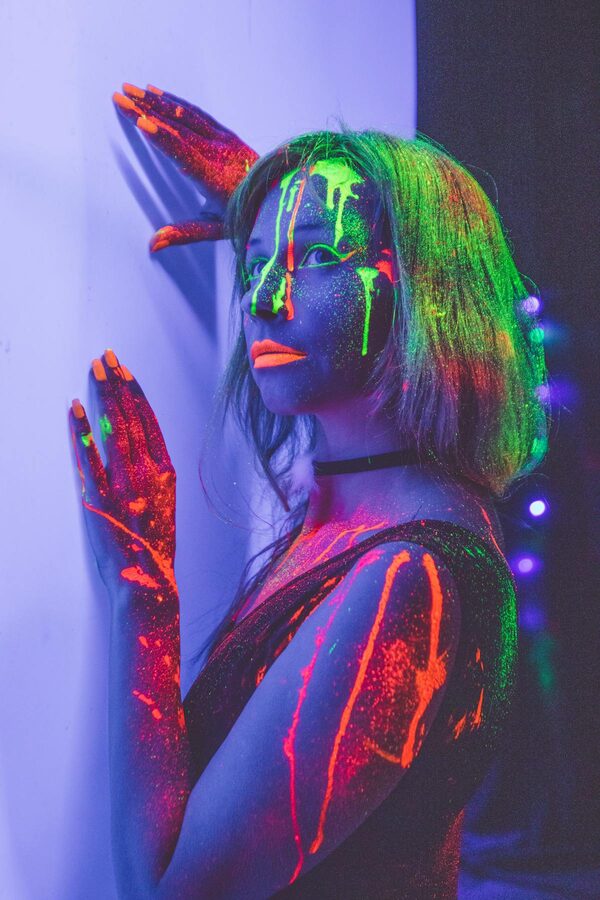Woman with fluorescent UV paint portrait