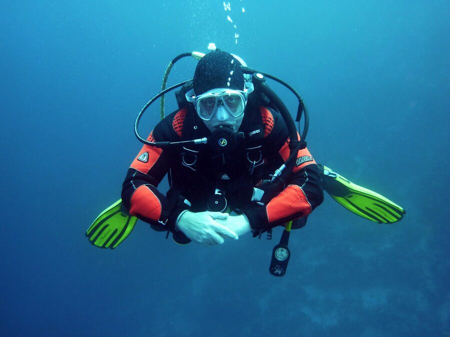Diver in drysuit exploring underwater