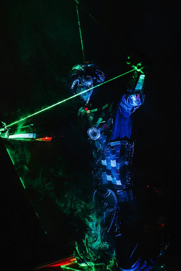 Performer in neon costume on dark stage