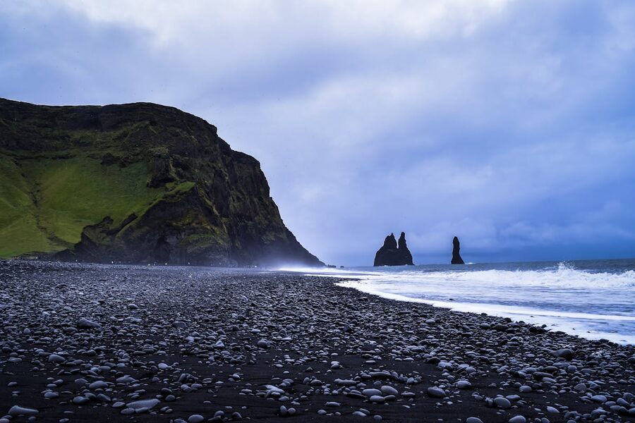 Reynisfjara black sand beach with basalt sea stacks Iceland