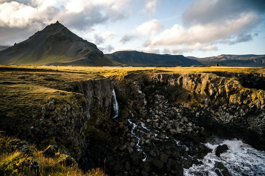 Moss-covered lava fields stretching toward mountains in Iceland