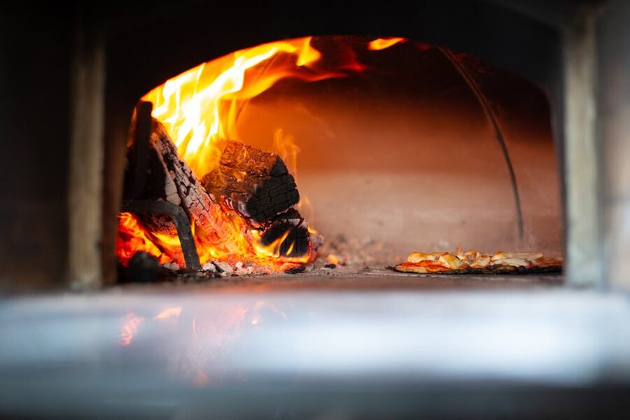 Pizza oven with flames baking