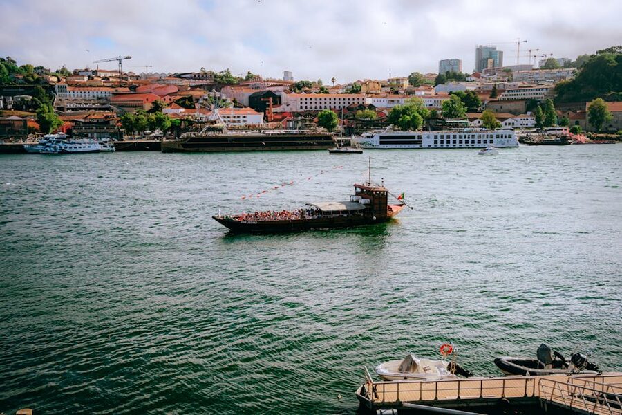 Tourists on a cruise on the Douro River with Porto's skyline in view