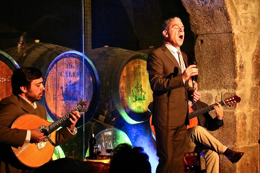Fado singer and guitarists performing at a Porto venue
