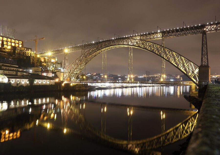 Dom Luis I bridge at evening reflected in Douro river, Porto