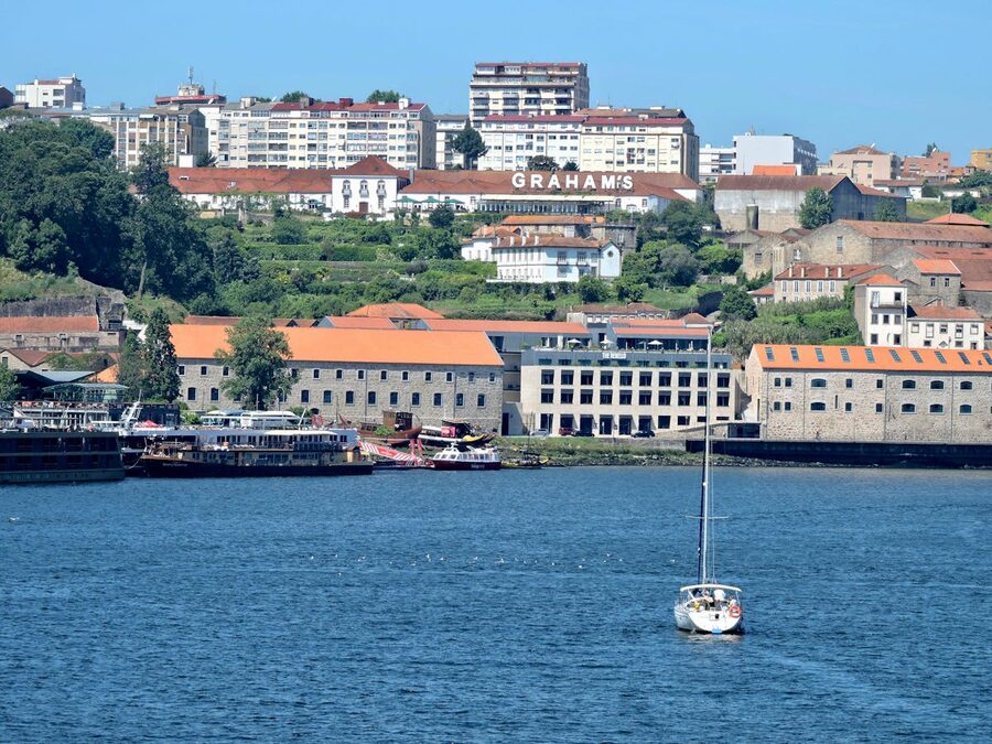 Sailboat on the Douro River with Porto skyline behind