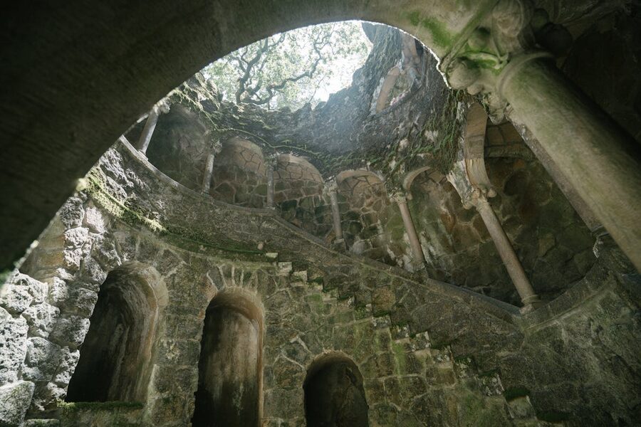 Looking down into the Initiation Well at Quinta da Regaleira showing spiral stone staircase