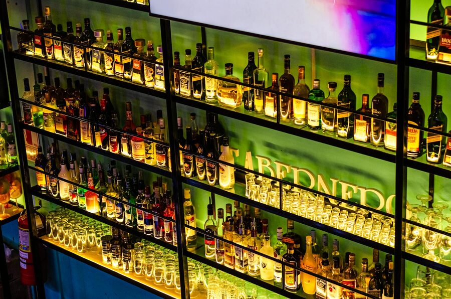 Illuminated bar shelves with liquor bottles