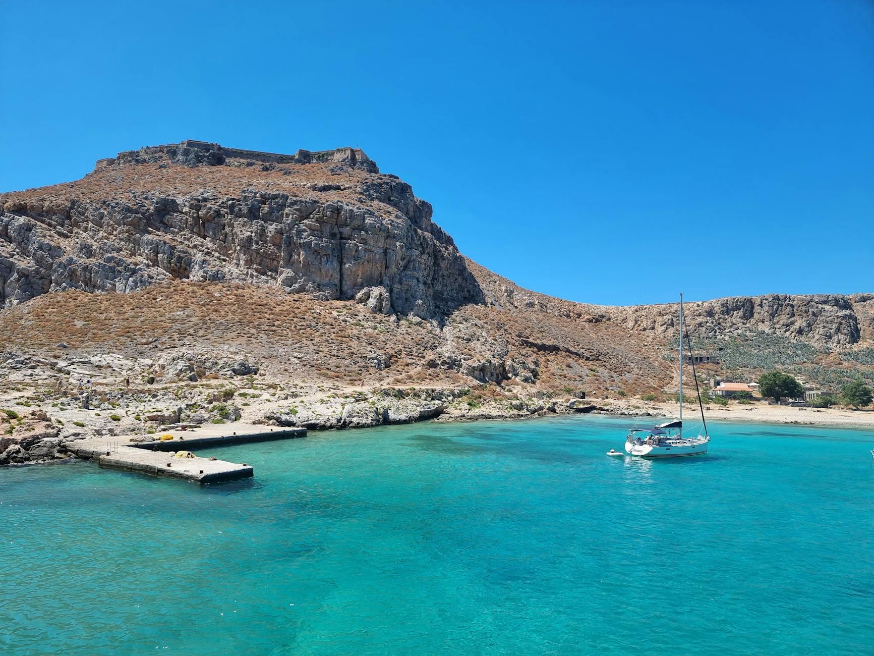 Sailboat in turquoise waters near Crete