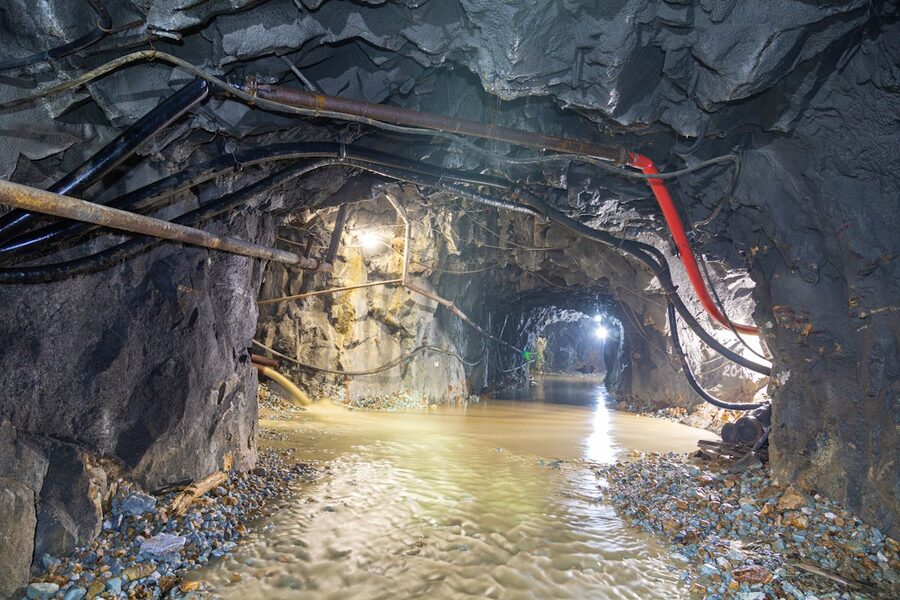 Mine tunnel with tracks and lighting