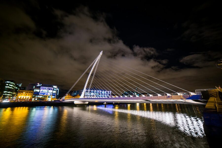 Samuel Beckett Bridge illuminated at night over the River Liffey