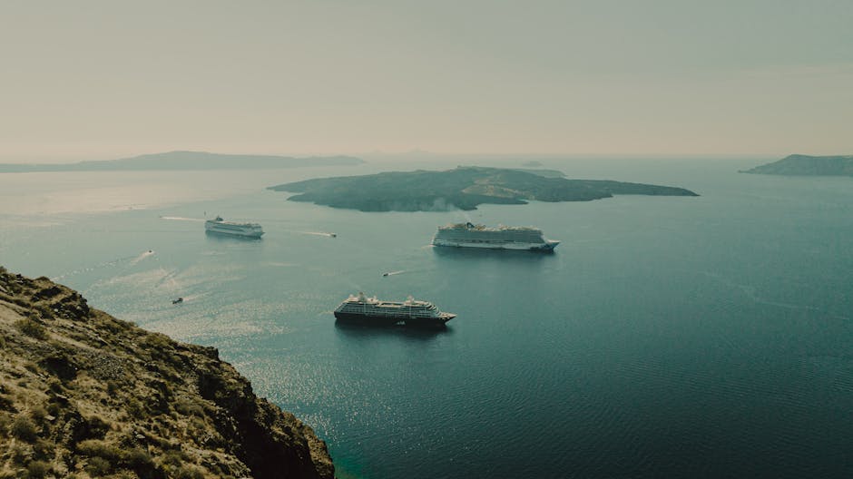 Catamaran and sailing boats in the Santorini caldera