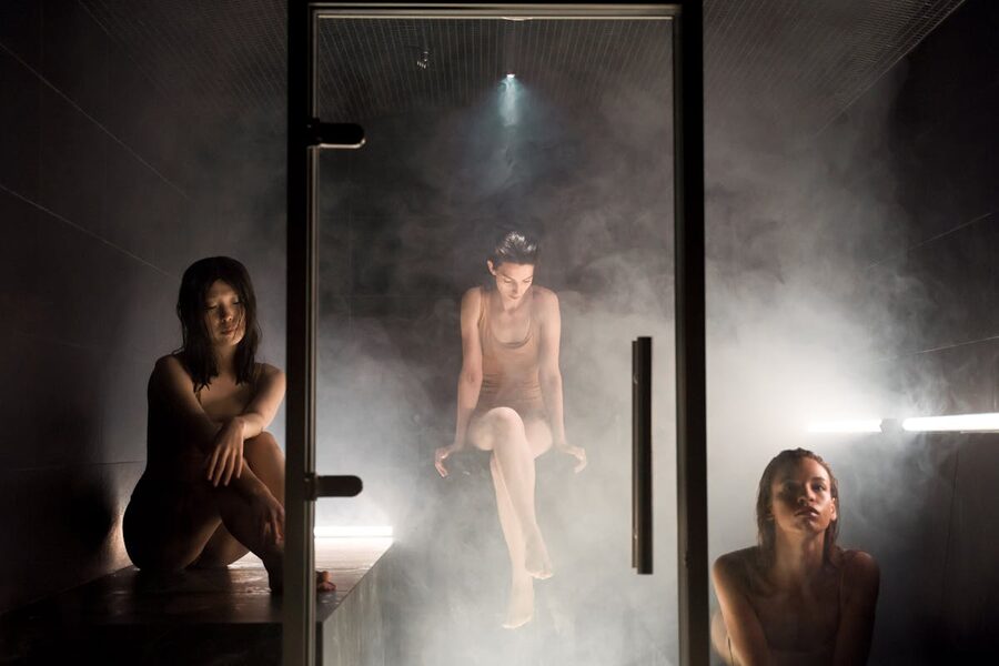 Women relaxing in steam-filled sauna