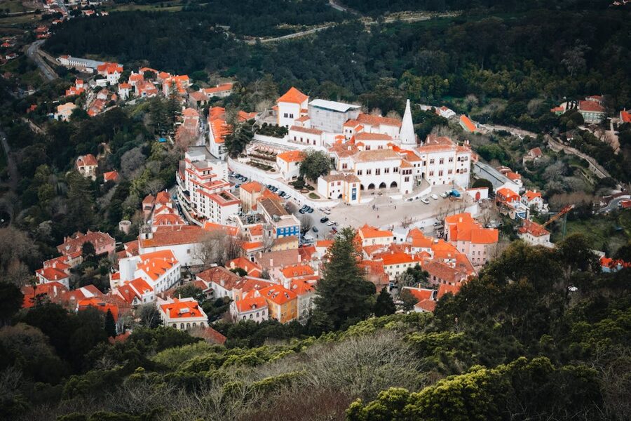 Aerial view of Sintra National Palace with twin chimneys surrounded by town