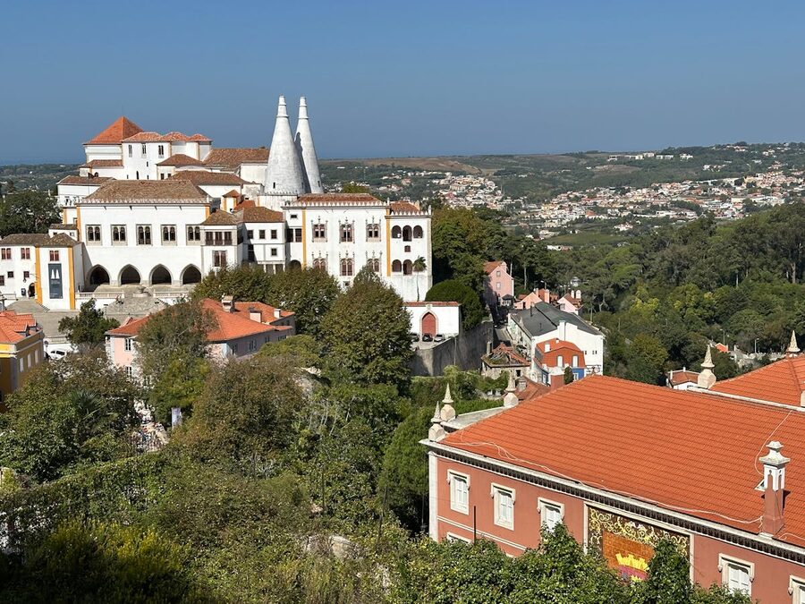 Sintra National Palace surrounded by rooftops and green hills in Portugal