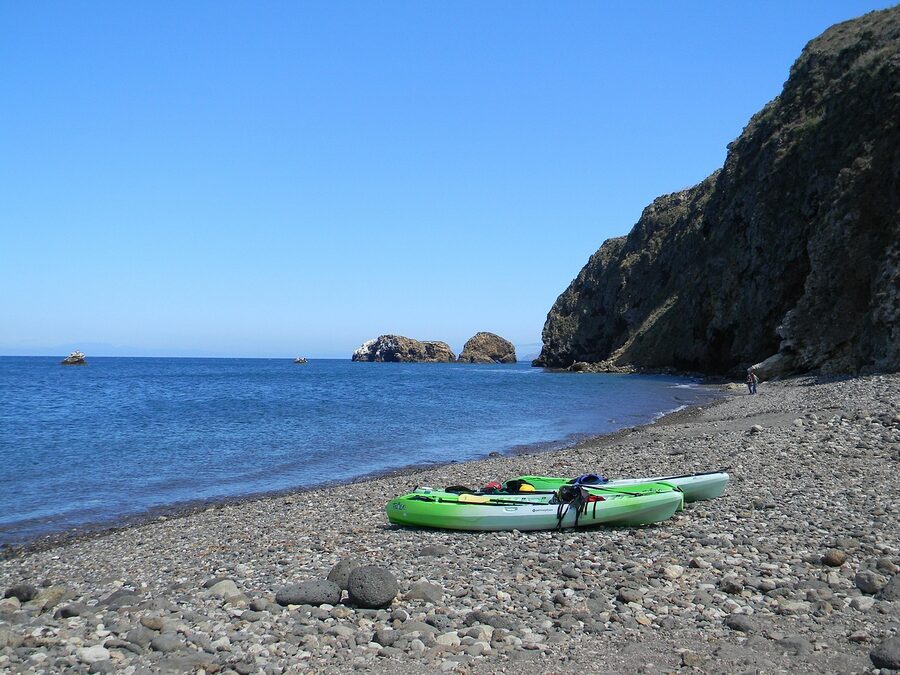 Sit-on-top kayaks on a beach ready for launch