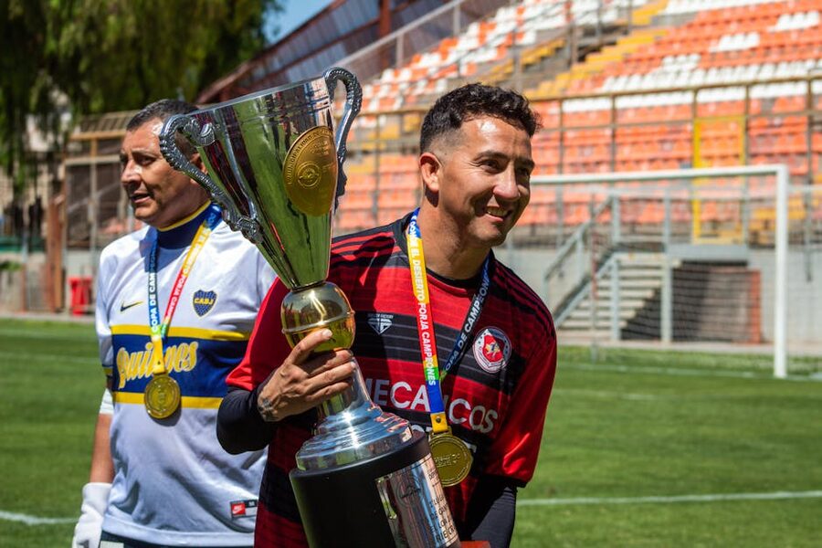 Soccer players celebrating with championship trophy