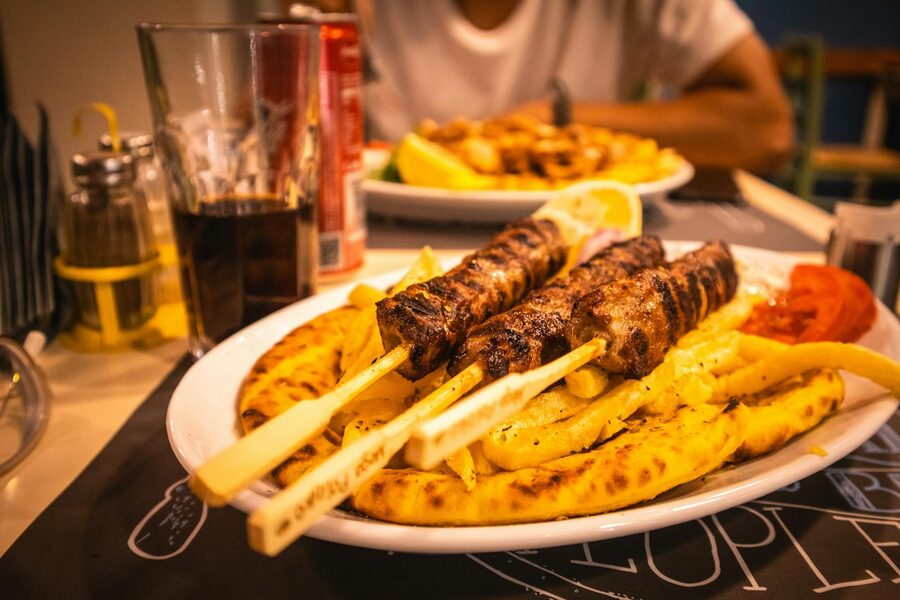 Grilled pork souvlaki skewers with pita bread at an Athens restaurant