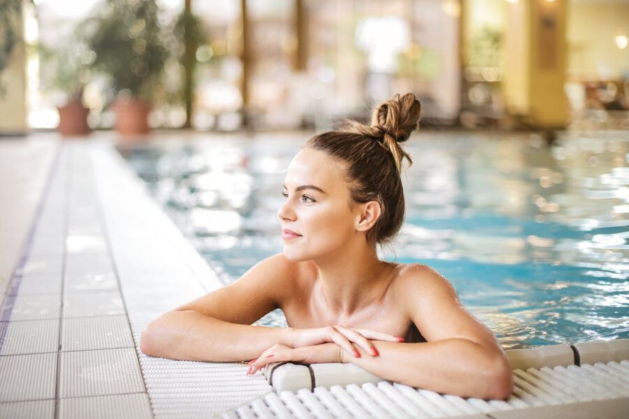 Woman relaxing in poolside setting at resort