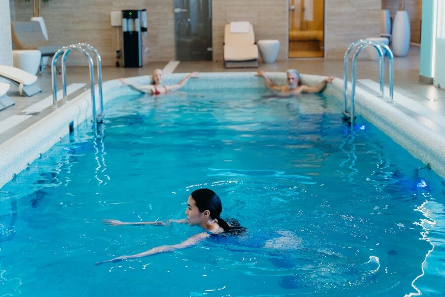 Adults swimming in indoor pool