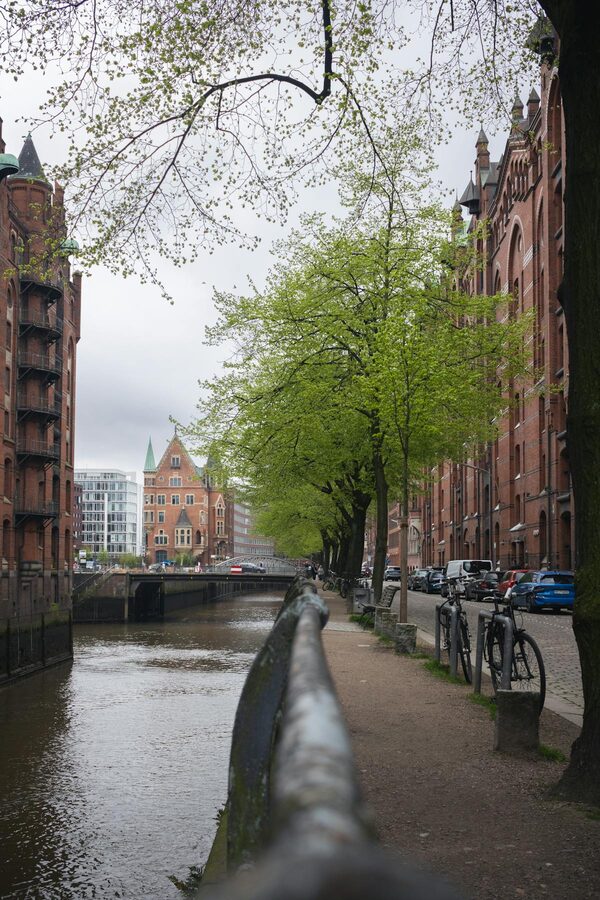 Cobblestone path alongside a canal in Hamburg's historic Speicherstadt