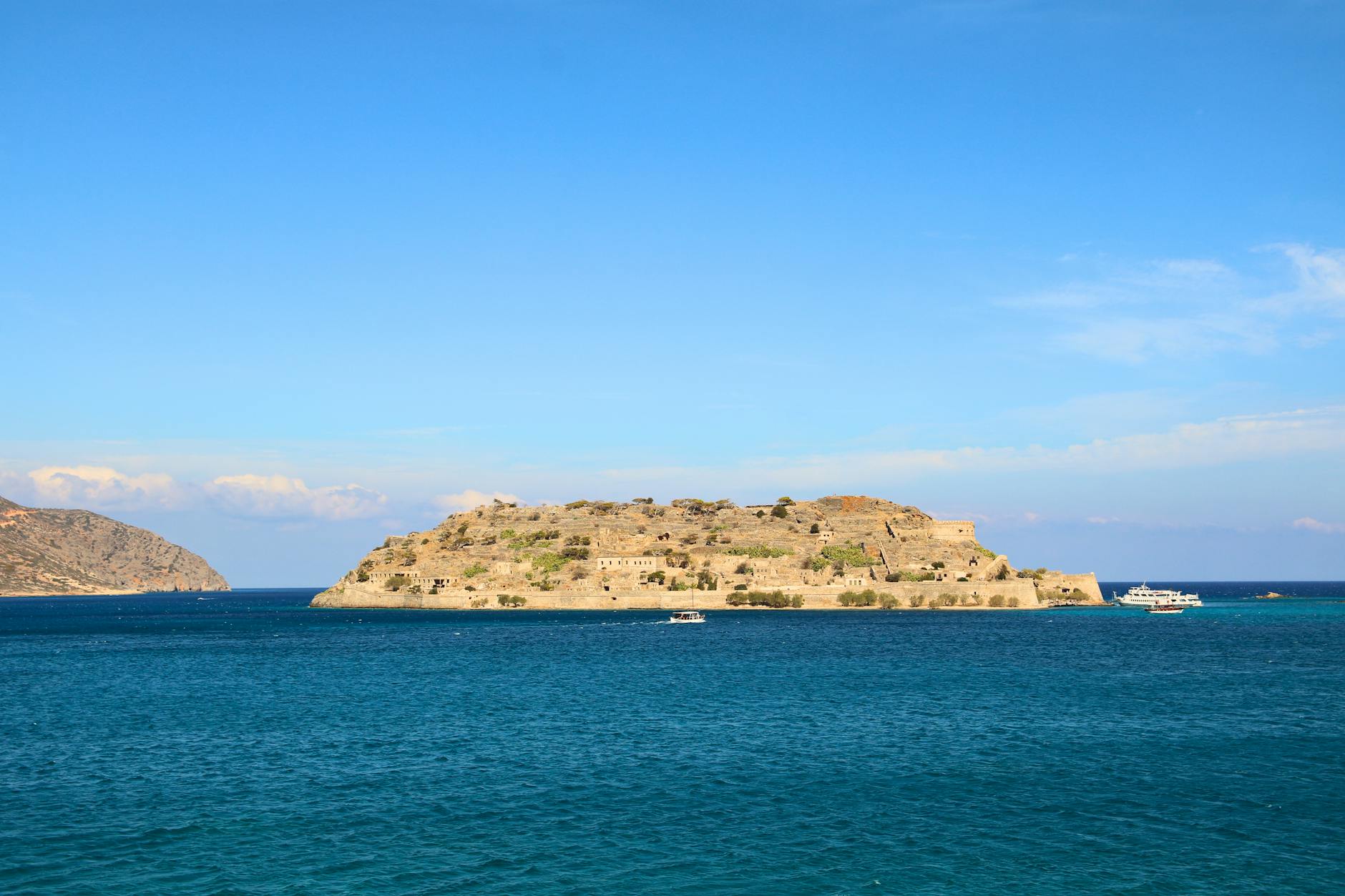 Spinalonga island surrounded by deep blue Mirabello Gulf waters