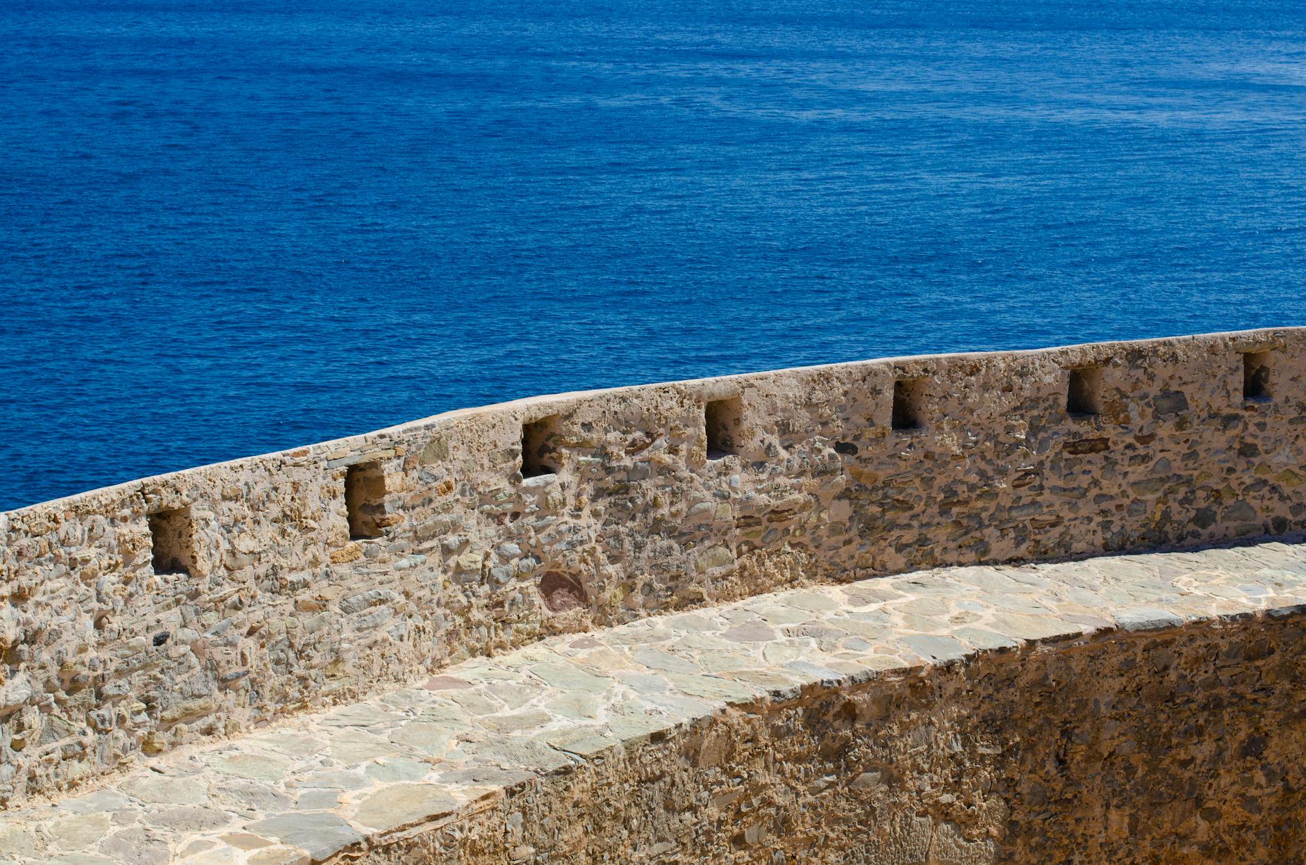 Historic stone fortress wall overlooking Spinalonga island
