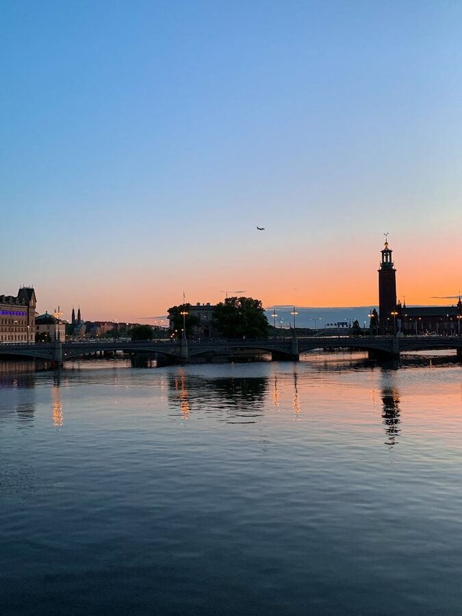 Stockholm City Hall and bridge at sunset with water reflections