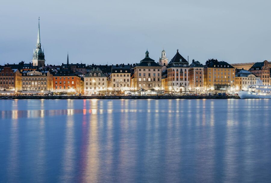Stockholm waterfront at twilight with historic buildings reflected in water