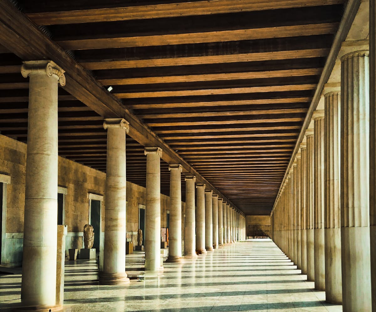 Sunlight streaming through the historic Stoa of Attalos columns in Athens