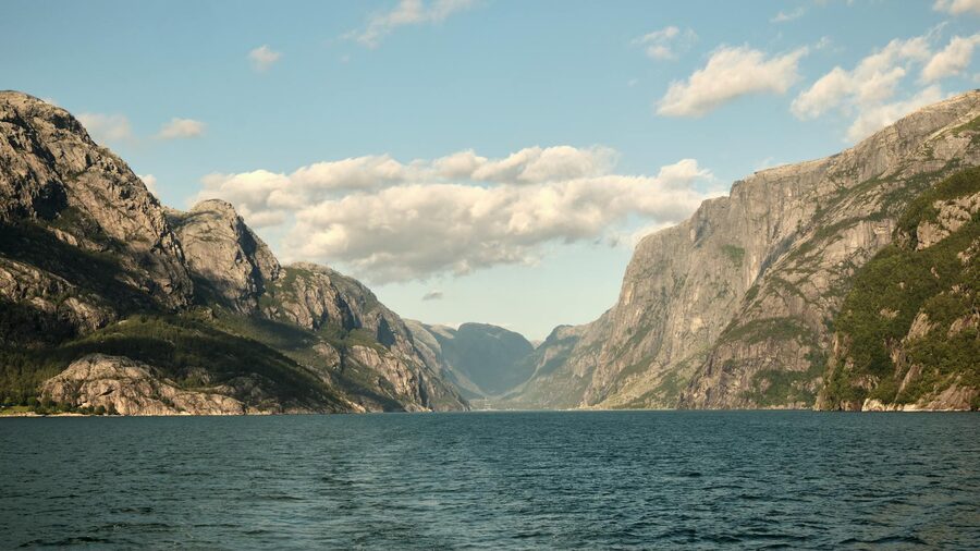 Calm water of the Lysefjord with mountains on both sides