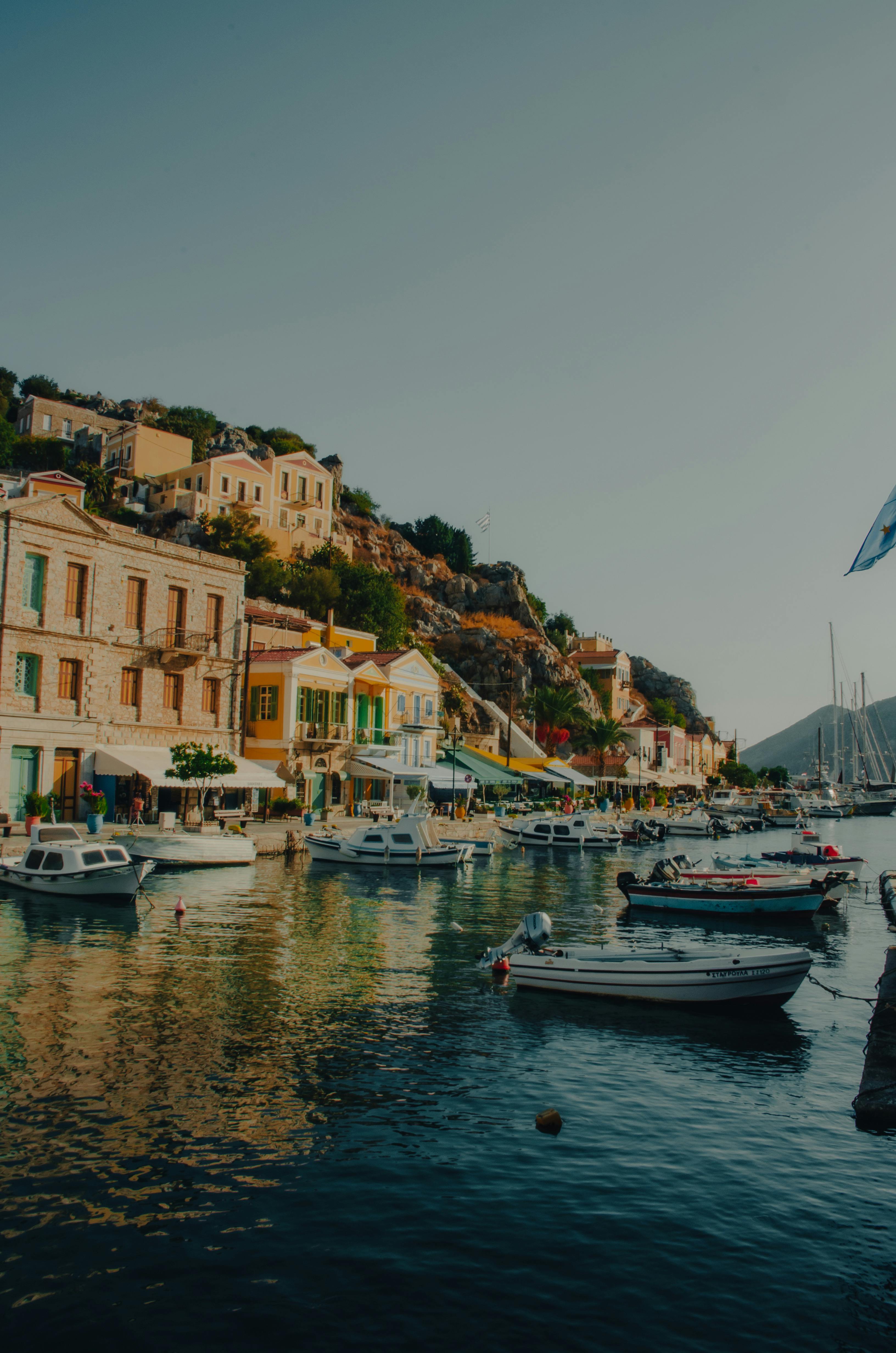 Waterfront view of boats in Symi, Greece against colorful architecture