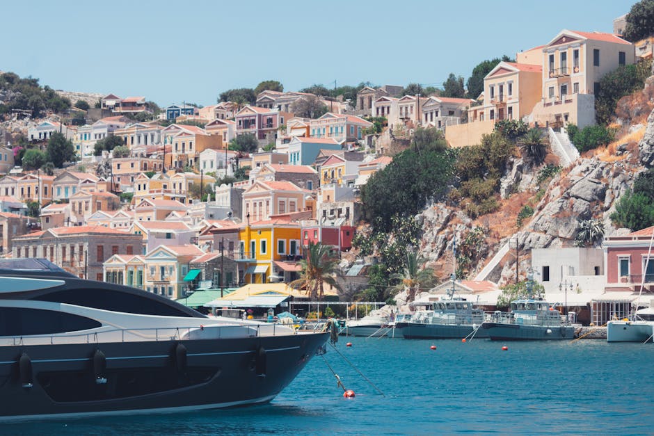 Pastel painted houses climbing the hillside above Symi town