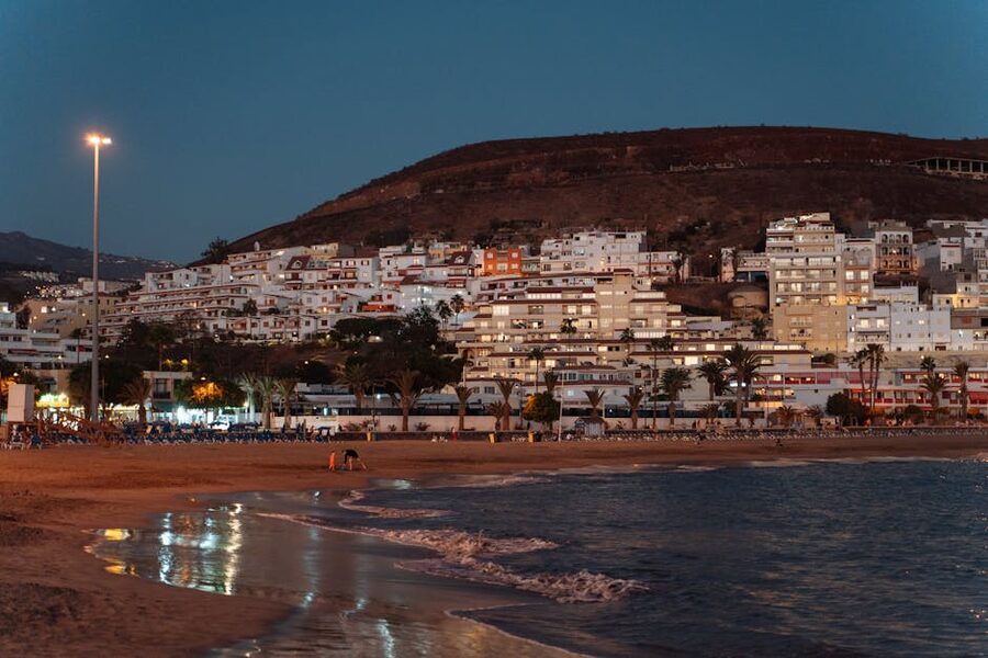 Los Cristianos evening beach with illuminated buildings
