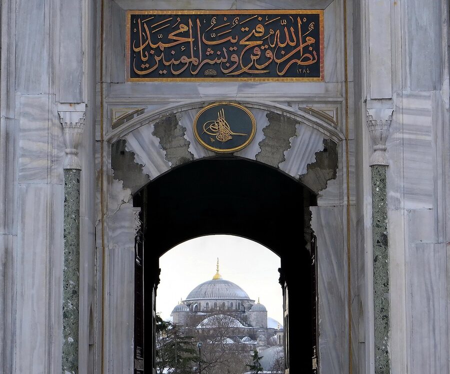 Imperial Gate of Topkapi Palace with Blue Mosque visible in the background