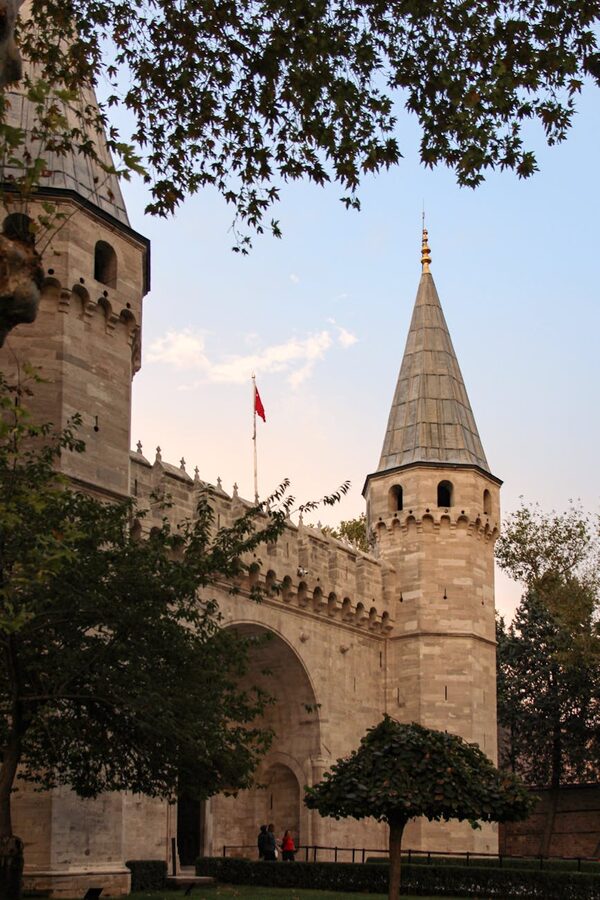 Topkapi Palace entrance with towers at sunset in Istanbul