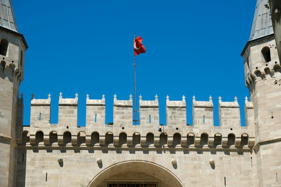 Topkapi Palace entrance gate with Turkish flag flying above