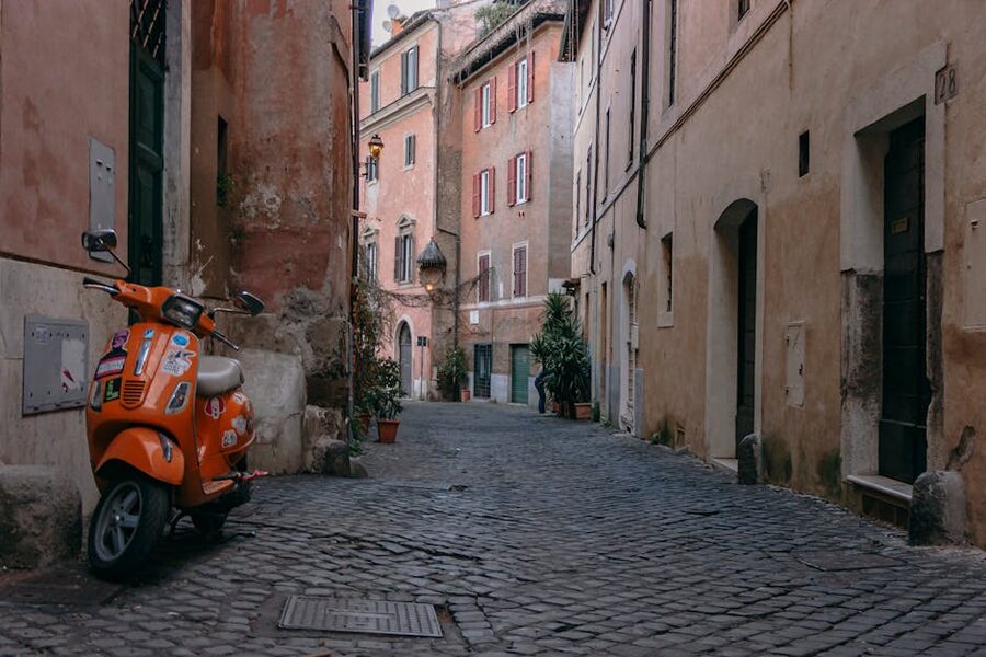 Cobblestone street in Trastevere, Rome with orange scooter