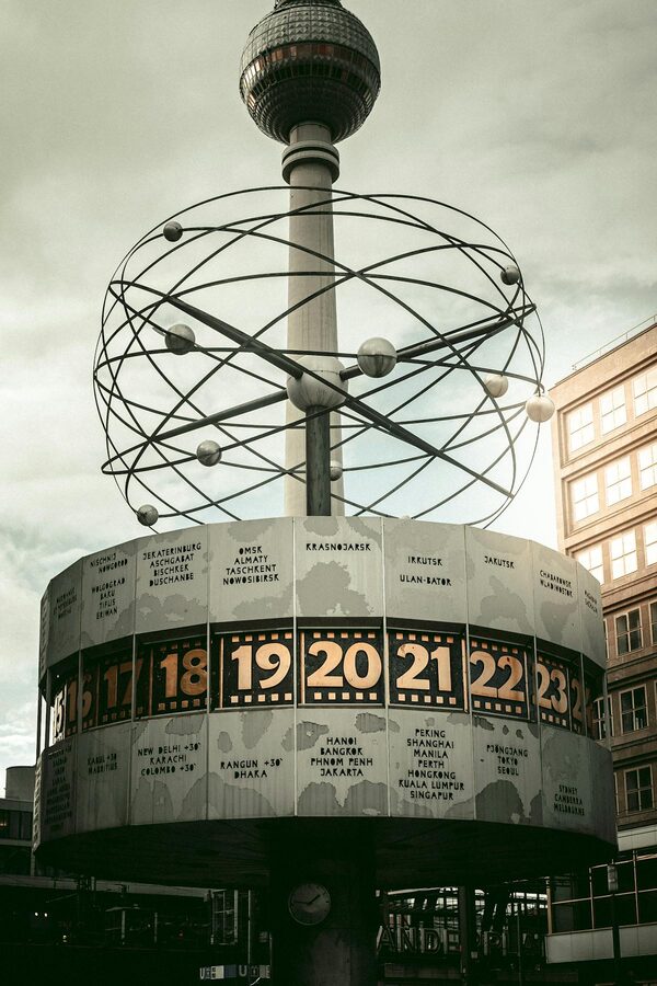 The World Clock at Alexanderplatz in Berlin with the TV Tower behind it