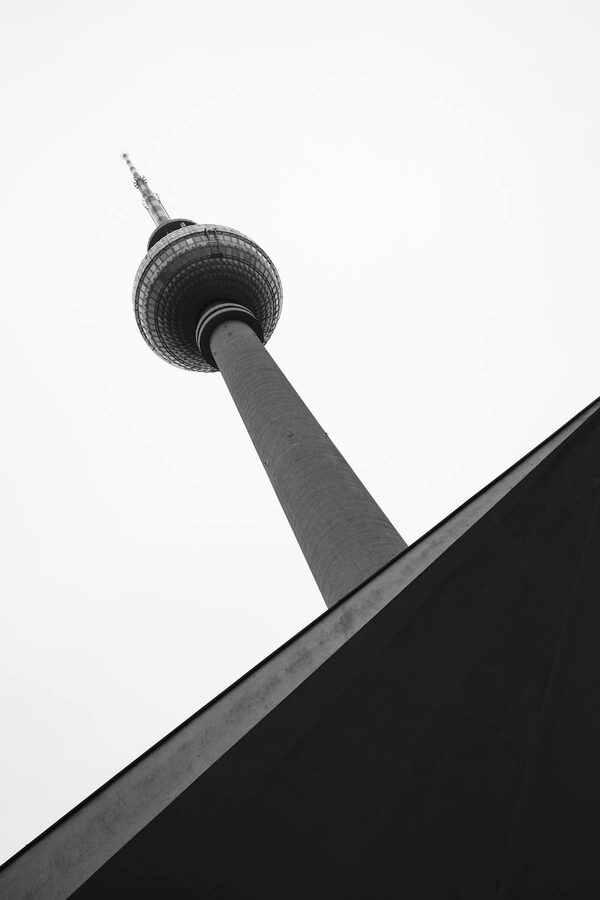 Black and white artistic low angle photograph of Berlin Fernsehturm TV Tower