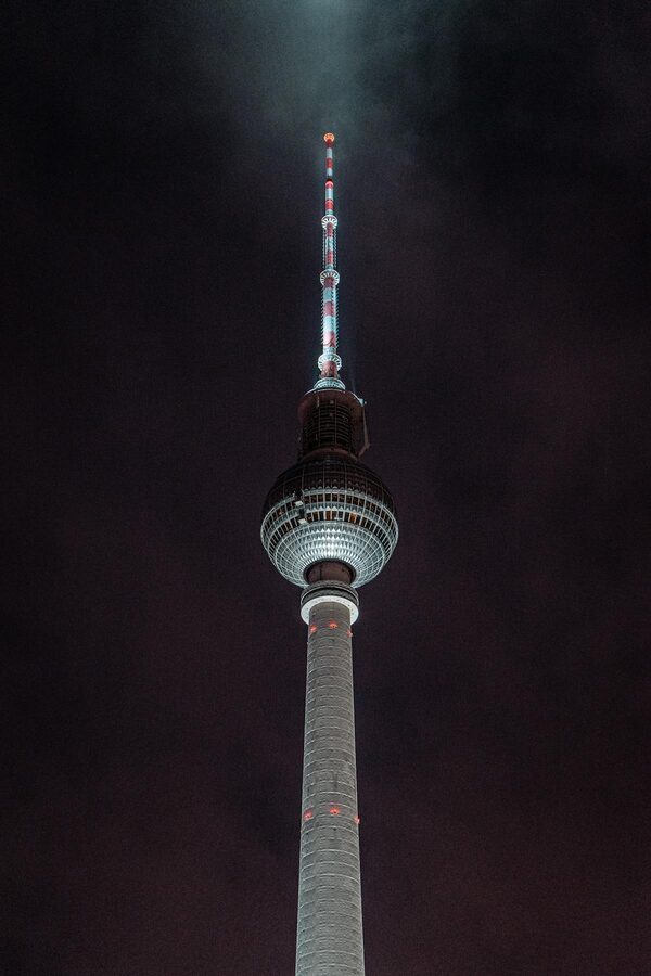 Berlin TV Tower illuminated at night against dark sky