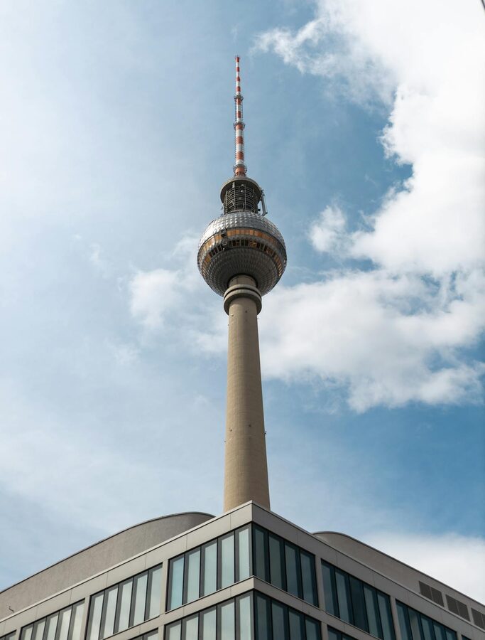 Low angle view of Berlin TV Tower on a sunny day with clouds in the sky