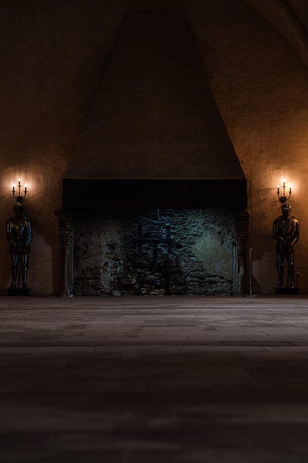 Castle interior with suits of armor and fireplace