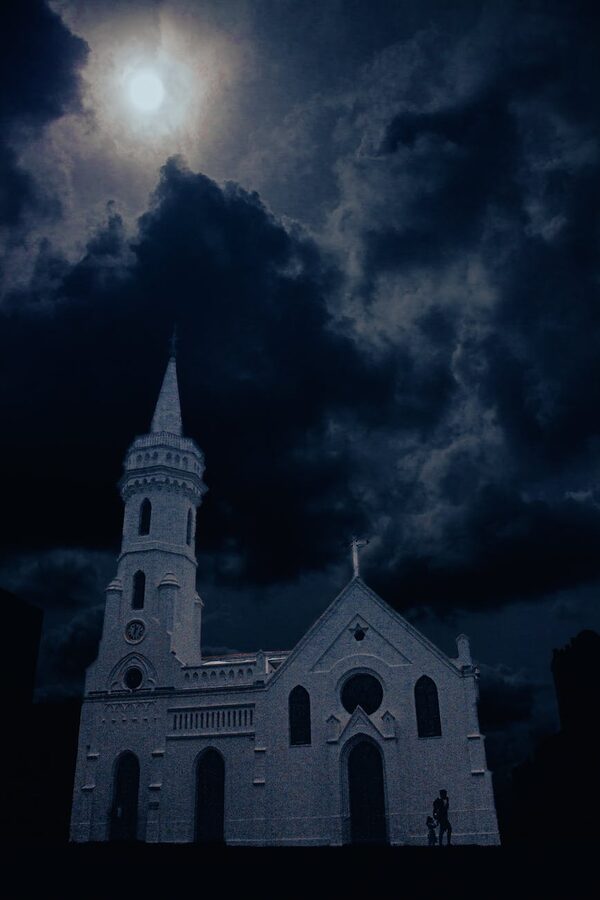 Gothic church against dramatic nighttime sky