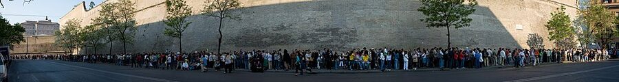 Long queue of visitors waiting along the Vatican walls to enter the museums