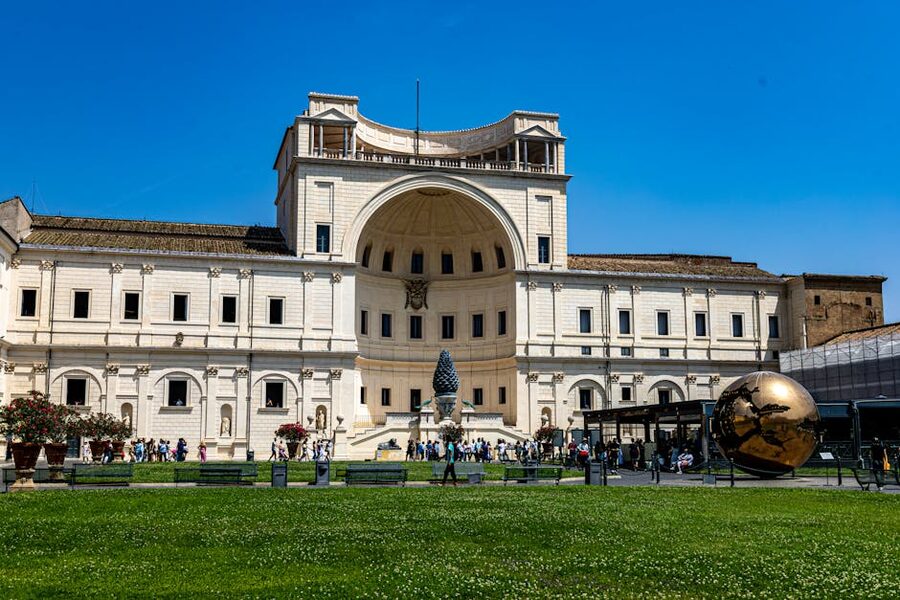 Visitors in the Vatican Museums courtyard on a sunny day