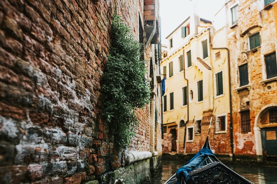 Venice gondola in a canal with historic buildings