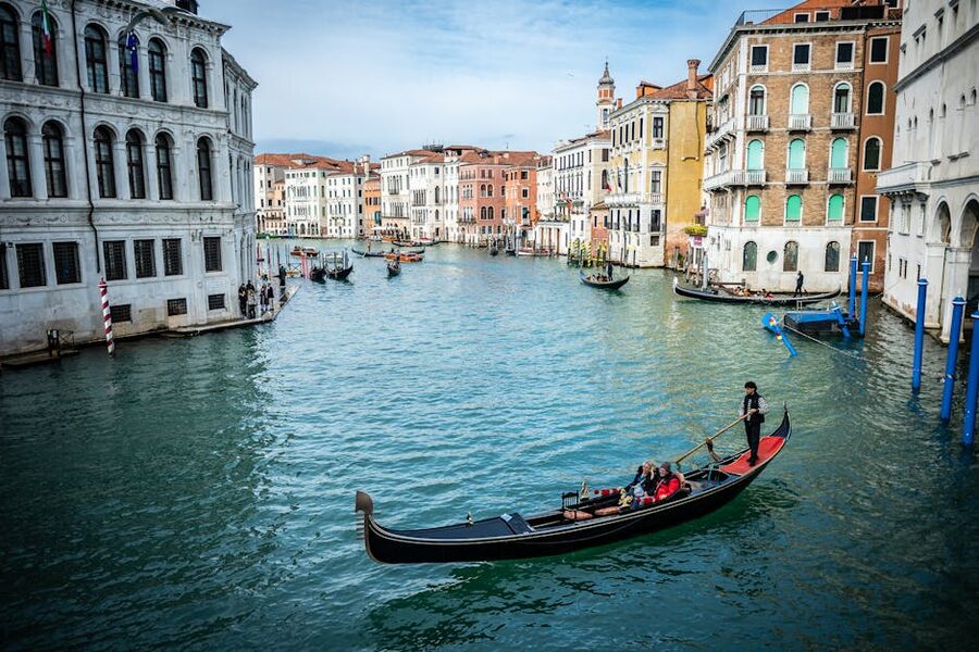 Gondola gliding through Venice Grand Canal with architecture