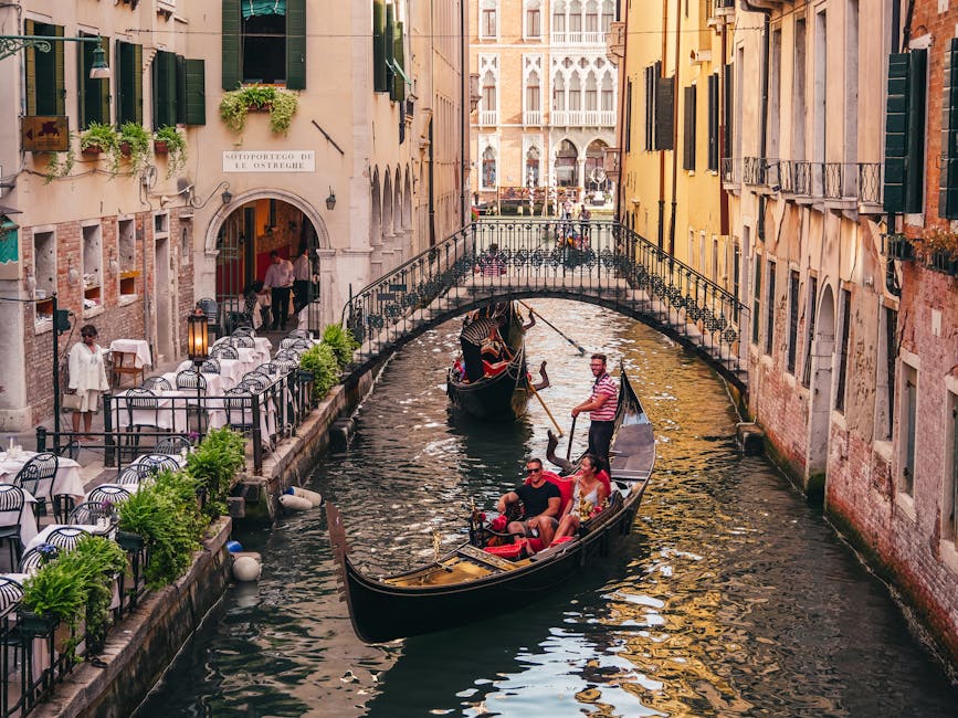 Gondolas navigating a Venice canal